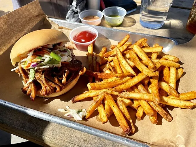 The pulled pork sandwich: where smoky meets savory in a bun-hugging embrace. Those fries? They're not just along for the ride.