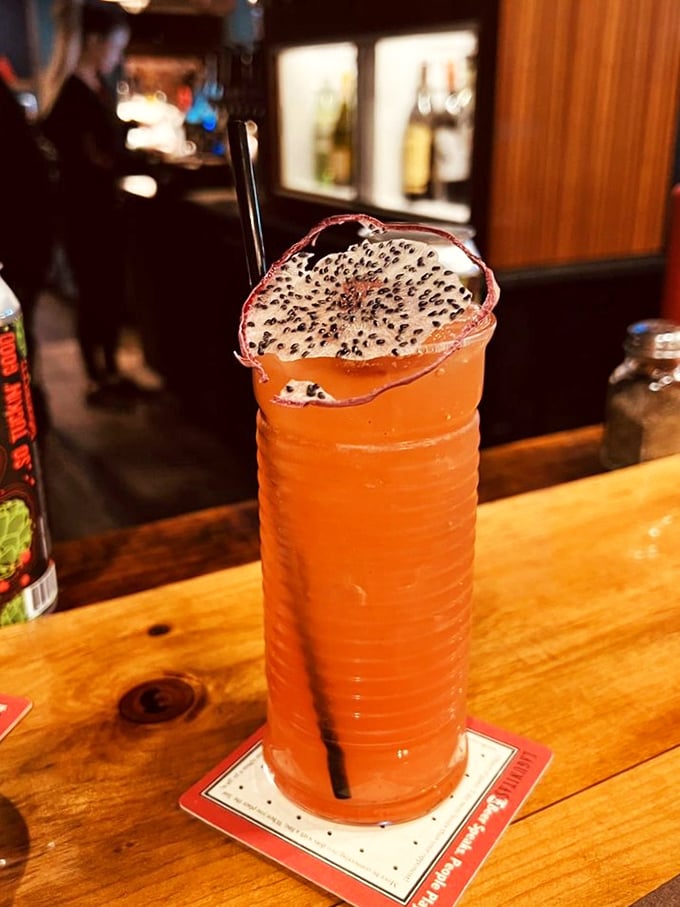 This isn't just a cocktail—it's an adult Dragon's Blood potion garnished with what appears to be a magical dragon fruit slice.