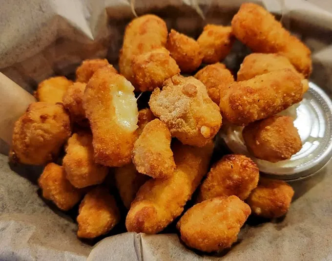 Cheese curds: Wisconsin's gift to the world. These golden nuggets of joy are like edible sunshine, brightening even the gloomiest day.