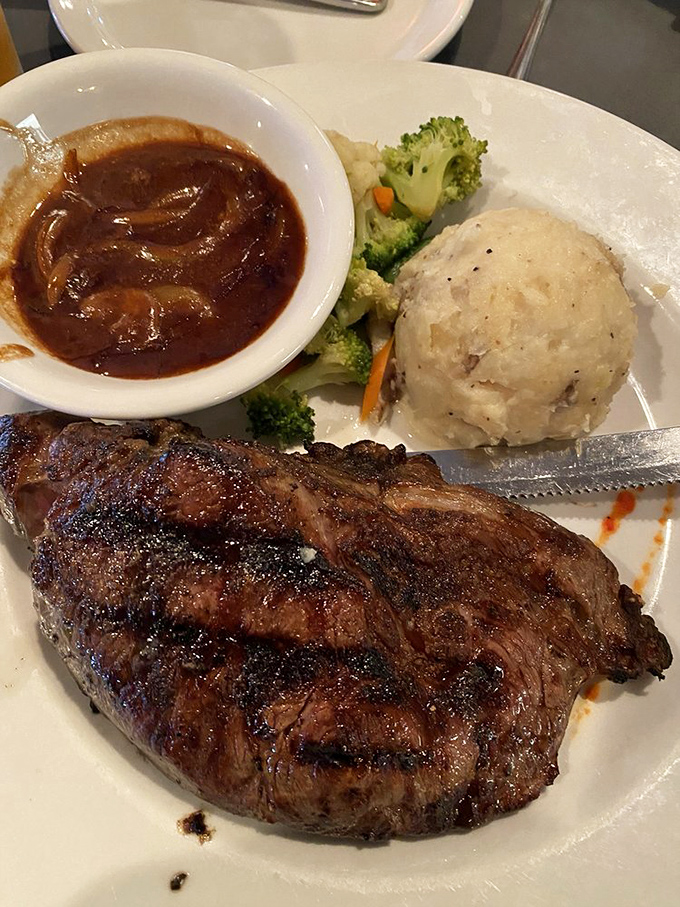 This ribeye isn't just a steak, it's a monument to bovine excellence. Vegetarians, avert your eyes – this is meat candy.