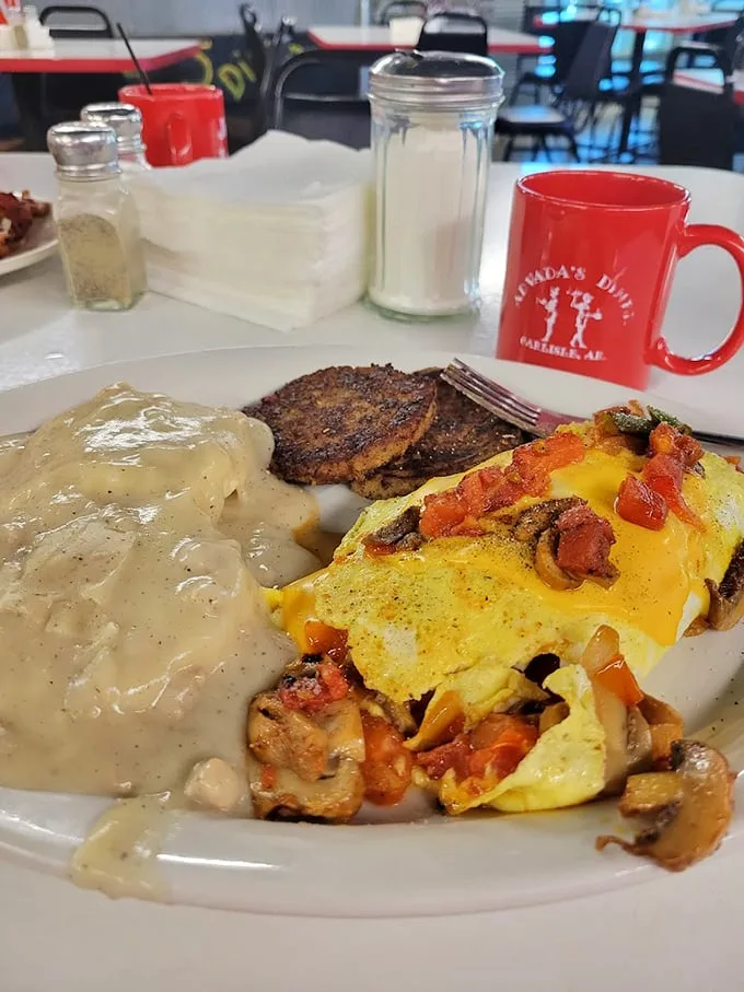 That omelet isn't just stuffed—it's having an identity crisis about whether it's breakfast or a complete three-course meal. The gravy settles the debate.