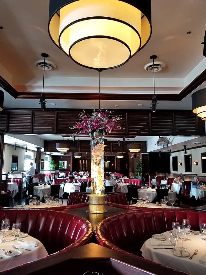 A dining room that's part swanky supper club, part seafood sanctuary. Those red booths are calling your name louder than a dinner bell.