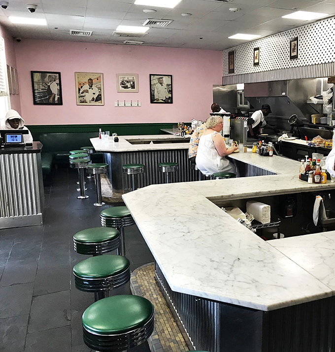 Diner dreams come true! Pink walls, polka dots, and mouth-watering aromas – it's like stepping into a 1950s foodie fantasy.