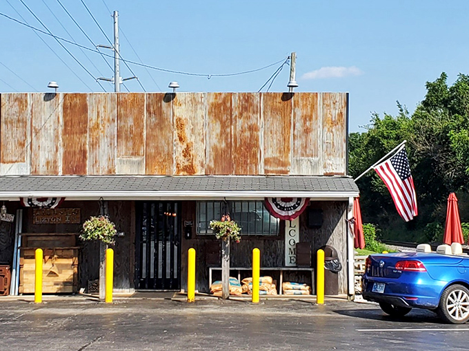 The weathered exterior of Rusted Silo isn't just authentic—it's a time machine disguised as a barbecue joint. Those yellow posts aren't just practical; they're exclamation points announcing culinary treasure.