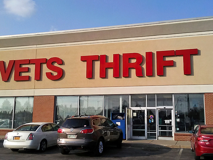 The bright red letters of AMVETS Thrift call to bargain hunters like a beacon, promising treasures waiting just beyond those doors.