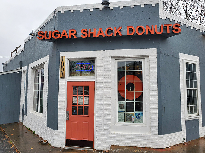 The blue-gray exterior with that coral door isn't just inviting—it's practically a siren song for your sweet tooth. Richmond's donut paradise awaits.