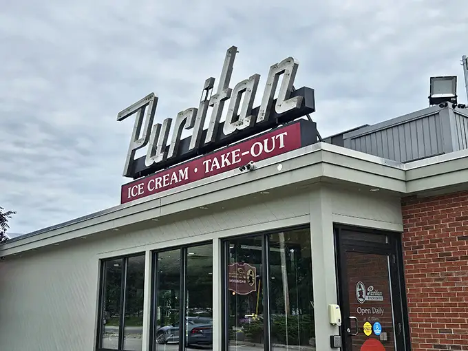 The iconic Puritan sign beckons like an old friend, promising ice cream and take-out treasures that have made Manchester residents swoon for generations.