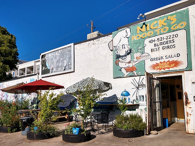 The unassuming white brick façade of Nick's Food To Go stands like a culinary lighthouse in Atlanta's urban landscape, beckoning hungry souls with its vintage sign.