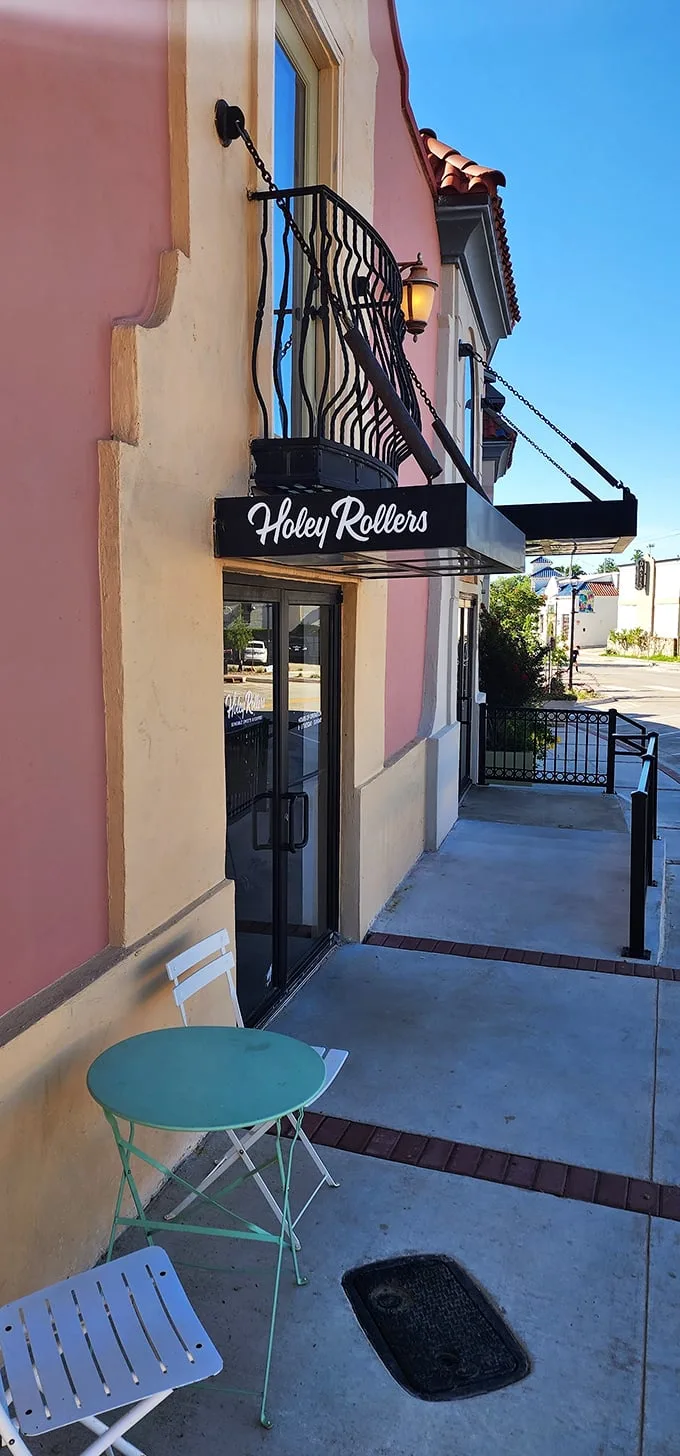 The peachy façade of Holey Rollers stands like a sweet beacon in OKC's Paseo Arts District, promising delicious revelations within those glass doors.