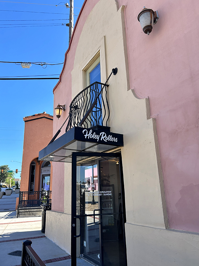 The peachy façade of Holey Rollers stands like a sweet beacon in OKC's Paseo Arts District, promising delicious revelations within those glass doors.