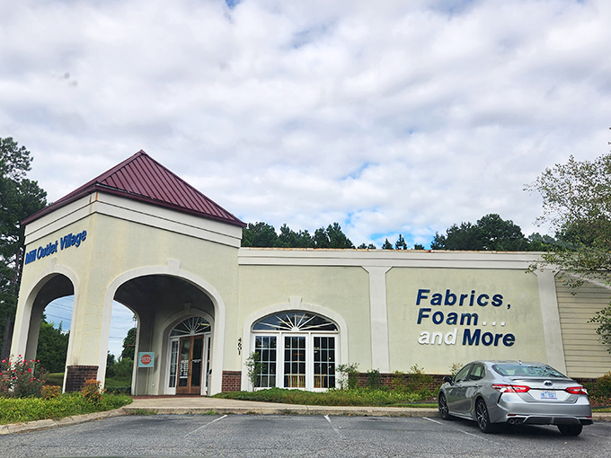 The inviting arched entrance of Mill Outlet Village promises fabric treasures within, like the wardrobe to Narnia for crafters.