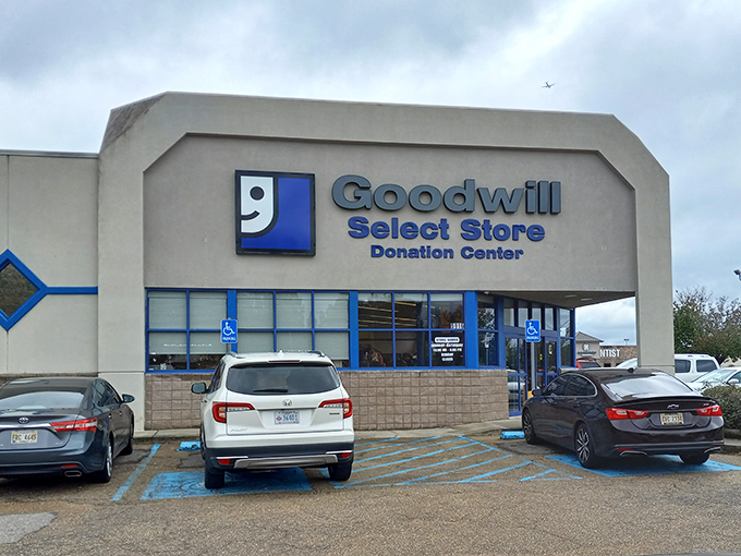 The iconic blue-and-white Goodwill Select Store facade stands ready to welcome treasure hunters under the Mississippi sun. 