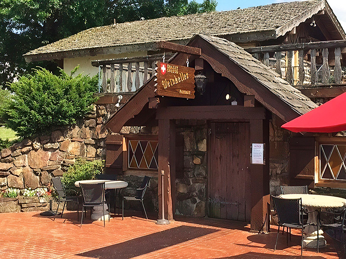 The Swiss chalet of your dreams isn't in the Alps—it's hiding in Arkansas! This stone-and-timber entrance promises Old World magic behind that wooden door.