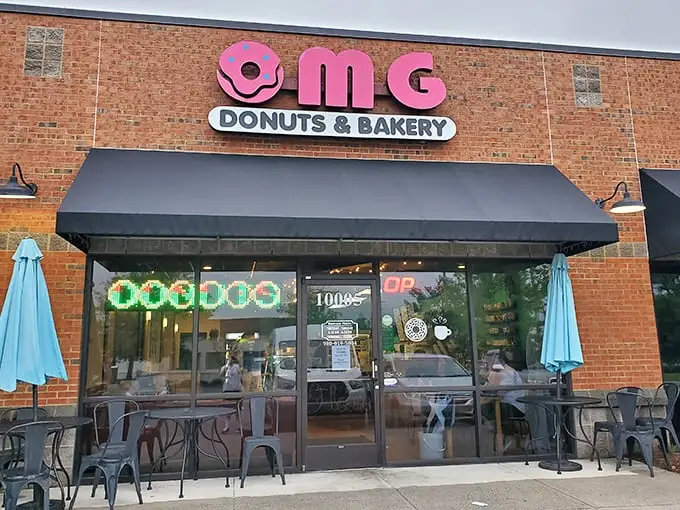 The pink donut sign beckons like a sugary lighthouse, promising sweet salvation for carb enthusiasts in Concord's unassuming strip mall.