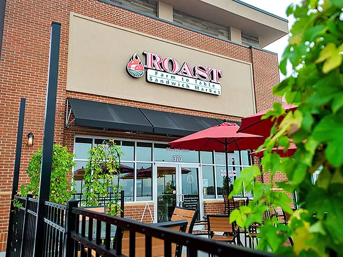 Roast's inviting brick façade with cheerful red umbrellas isn't just curb appeal – it's your first hint that sandwich nirvana awaits inside.