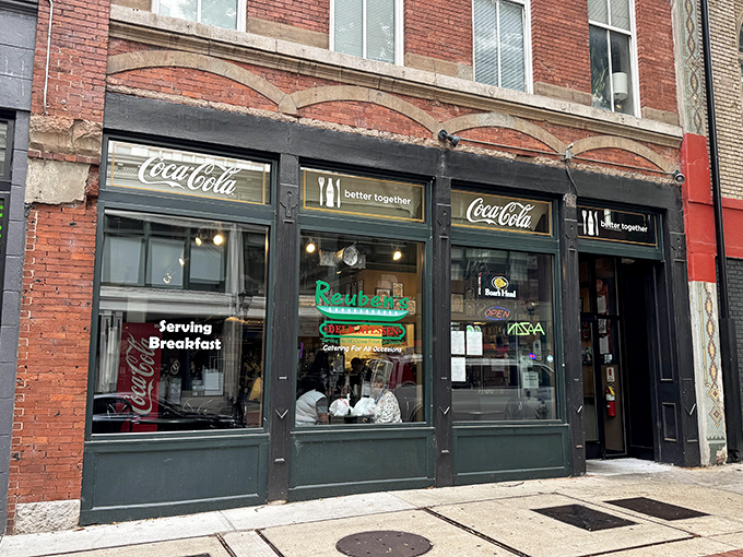 The historic brick façade of Reuben's Deli stands as a beacon for sandwich aficionados. That vintage sign promises delicious things await inside.
