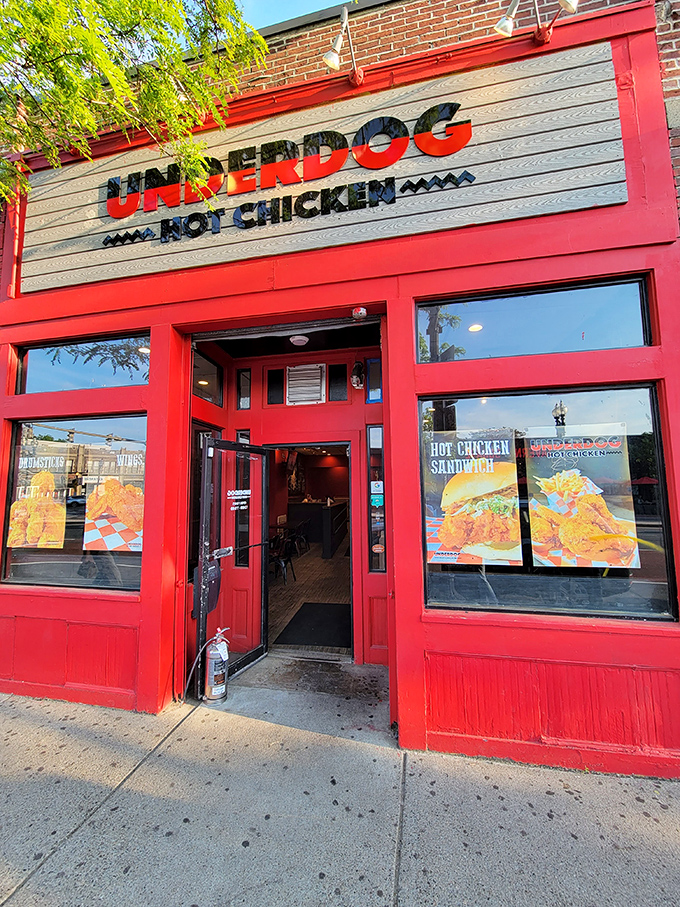 The bold red storefront of Underdog Hot Chicken stands out like a beacon for spice-seekers. Boston's hottest chicken joint announces itself without apology.