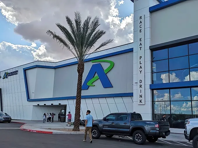The sleek exterior of Andretti Indoor Karting beckons speed enthusiasts with its modern design and that iconic blue "A" logo—racing paradise awaits inside.