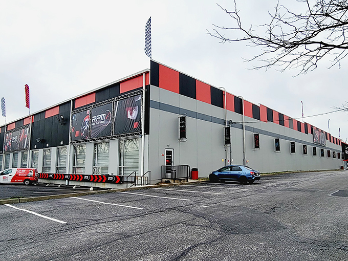 The red and black exterior of RPM Raceway stands like a temple to speed, promising adrenaline rushes inside its unassuming industrial shell.