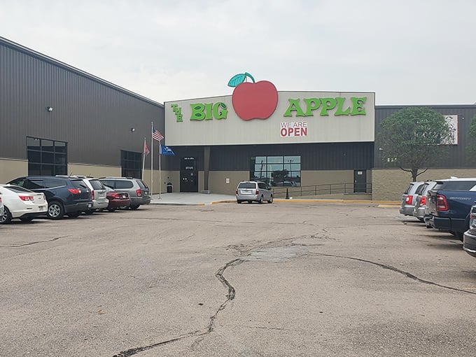The iconic red apple sign beckons fun-seekers like a beacon of joy amid the Nebraska plains. Entertainment paradise awaits inside!