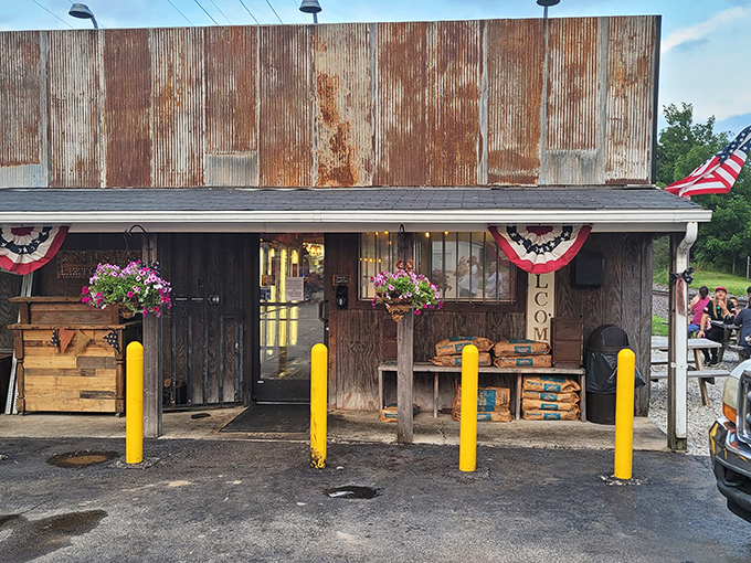 The weathered exterior of Rusted Silo isn't just authentic—it's a time machine disguised as a barbecue joint. Those yellow posts aren't just practical; they're exclamation points announcing culinary treasure.