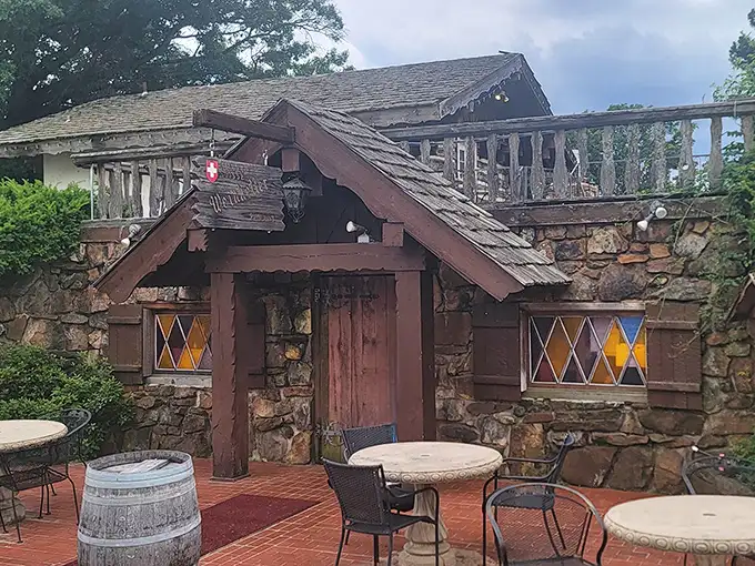 The Swiss chalet of your dreams isn't in the Alps—it's hiding in Arkansas! This stone-and-timber entrance promises Old World magic behind that wooden door.