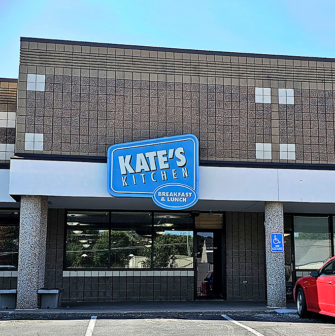 The blue sign beckons like a breakfast lighthouse, guiding hungry souls to Kate's Kitchen where morning miracles await in tortilla-wrapped glory. 