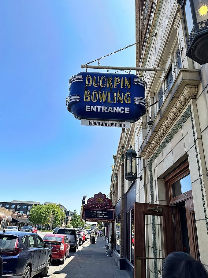 That blue neon sign beckons like a portal to another era—when entertainment moved at human speed and bowling had character.