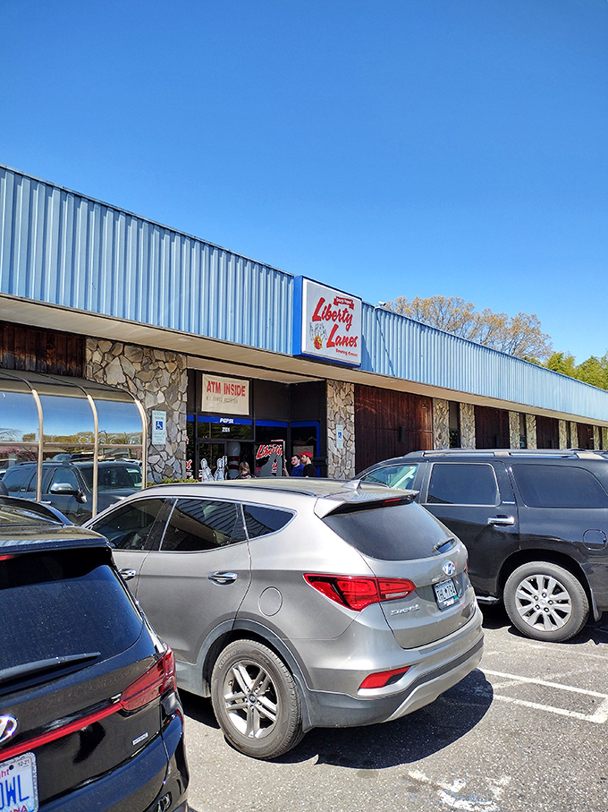 The classic stone facade and iconic blue signage of Liberty Lanes stands as a time capsule of American recreation—where memories are made one frame at a time.