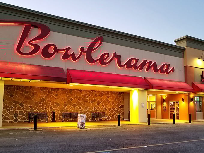 That iconic red neon sign glowing against the dusk sky isn't just advertising bowling—it's broadcasting a portal back to simpler times.