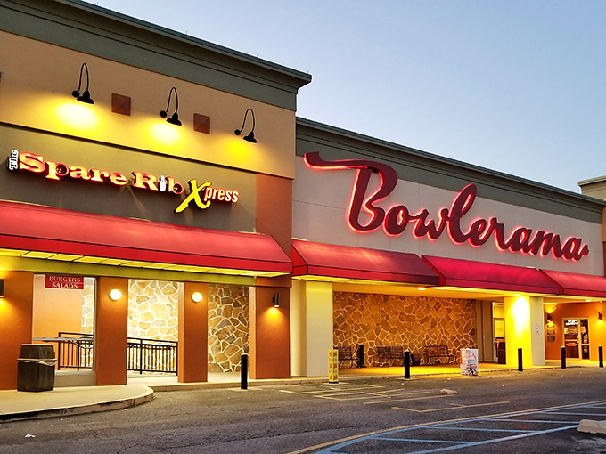 That iconic red neon sign glowing against the dusk sky isn't just advertising bowling—it's broadcasting a portal back to simpler times.