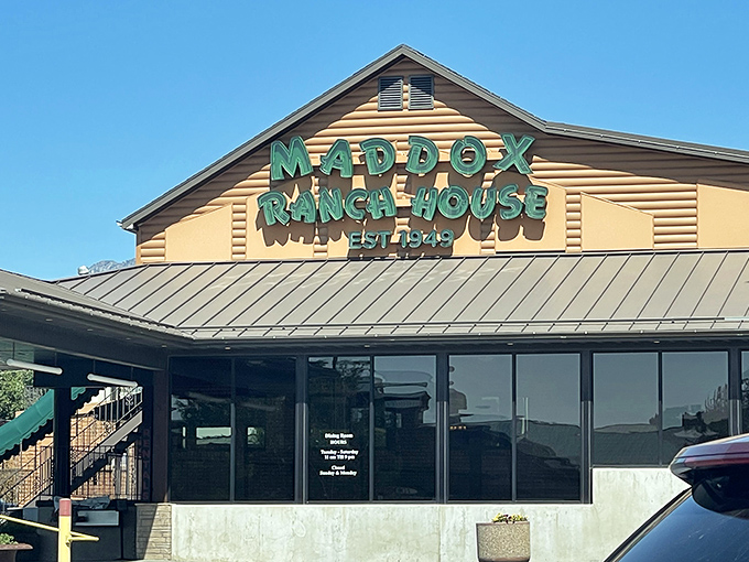 The glowing green sign of Maddox Ranch House beckons like a meaty lighthouse against the Utah mountains—a beacon of beef since 1949.