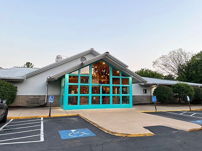 The turquoise-framed entrance of The Catfish Hole stands like a beacon of Southern comfort food, promising delicious treasures within its unassuming exterior.