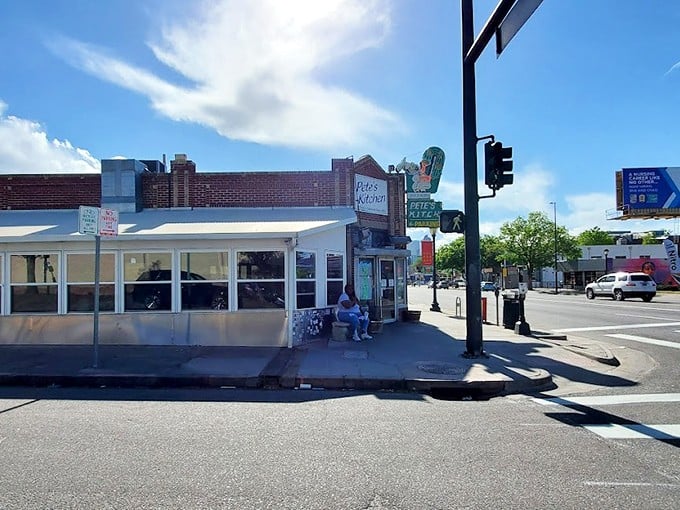 That iconic neon sign beckons like an old friend, promising comfort food and conversations that matter on Denver's storied Colfax Avenue.