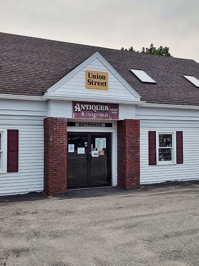 The unassuming exterior of Union Street Antiques beckons with its yellow sign and classic New England charm—a time portal disguised as a simple white building.