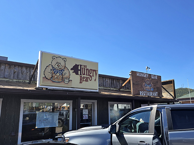 The rustic wooden exterior of Hungry Bear Restaurant stands proudly against Colorado's blue sky, promising comfort food that matches the mountain charm.