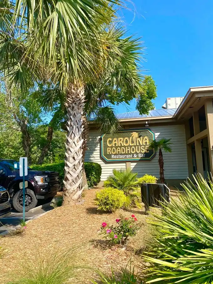 The welcoming façade of Carolina Roadhouse stands ready to transform your ordinary dinner into a memorable feast under Carolina's blue skies