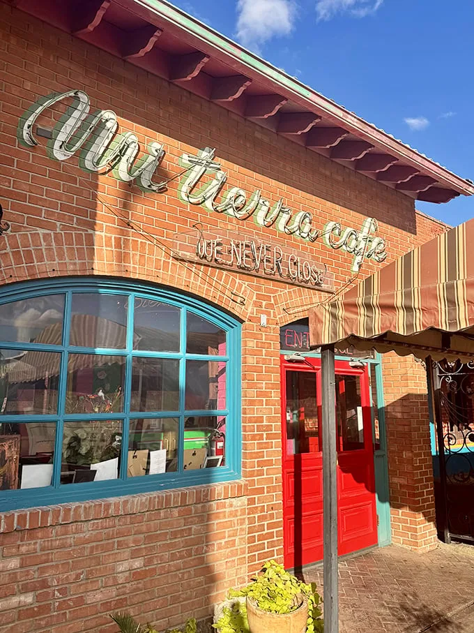 The brick exterior of Mi Tierra welcomes visitors with its colorful signage and potted plants—like a warm Mexican hug in the heart of San Antonio.