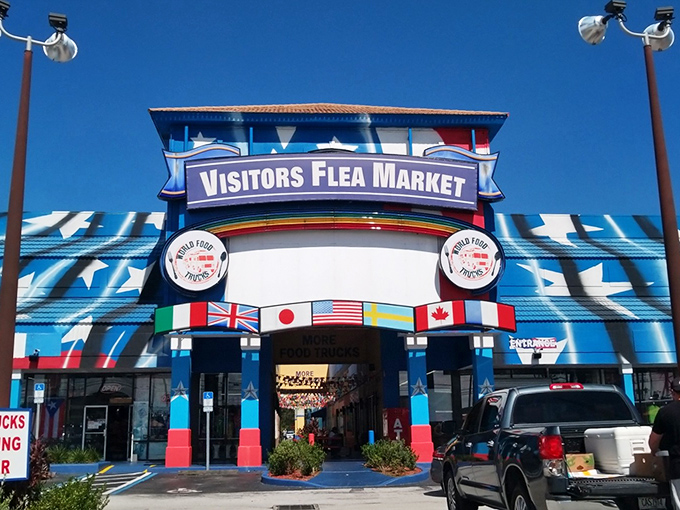 The blue-starred facade of Visitors Flea Market stands like a retail United Nations, complete with international flags welcoming bargain hunters from around the globe.