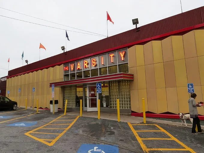 The iconic yellow and red exterior of The Varsity stands like a time capsule of American dining, beckoning hungry travelers with its retro charm.
