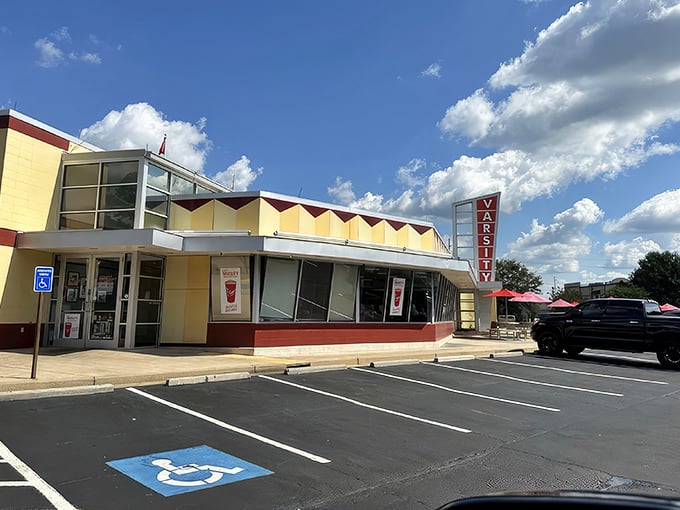 The iconic yellow and red exterior of The Varsity stands like a time capsule of American dining, beckoning hungry travelers with its retro charm.