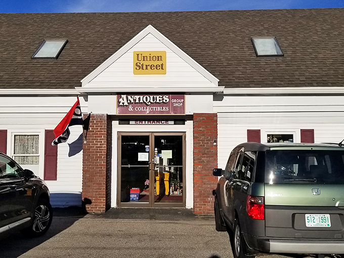 The unassuming exterior of Union Street Antiques beckons with its yellow sign and classic New England charm—a time portal disguised as a simple white building.