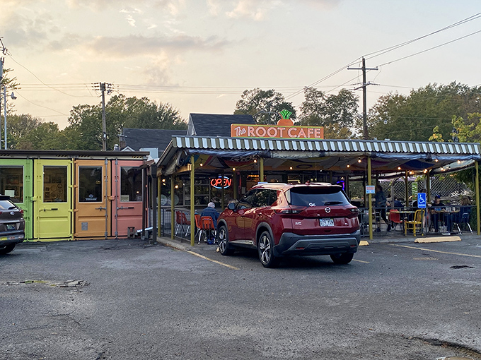The unassuming exterior of The Root Cafe, where culinary magic hides behind a modest facade topped with that iconic carrot sign.