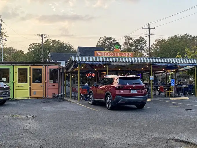 The unassuming exterior of The Root Cafe, where culinary magic hides behind a modest facade topped with that iconic carrot sign.