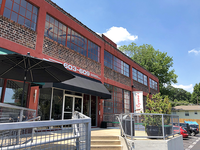 The unassuming red brick exterior of Cyrano's Cafe stands like Clark Kent before transformation – no cape needed, just carrot cake within.