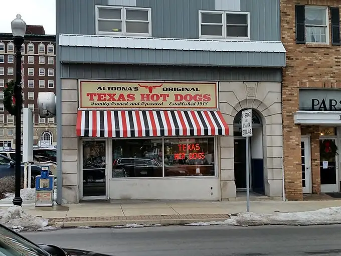The iconic red and white striped awning of Texas Hot Dogs glows like a beacon for hungry travelers. A slice of Americana preserved on Altoona's 12th Avenue.