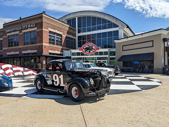 The checkered plaza welcomes speed enthusiasts like a starting line, with the sleek museum façade promising treasures that would make any gearhead's heart race faster than a qualifying lap.