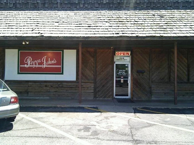 The unassuming exterior of Pizza John's in Derby might not stop traffic, but locals know this modest storefront houses pizza greatness.