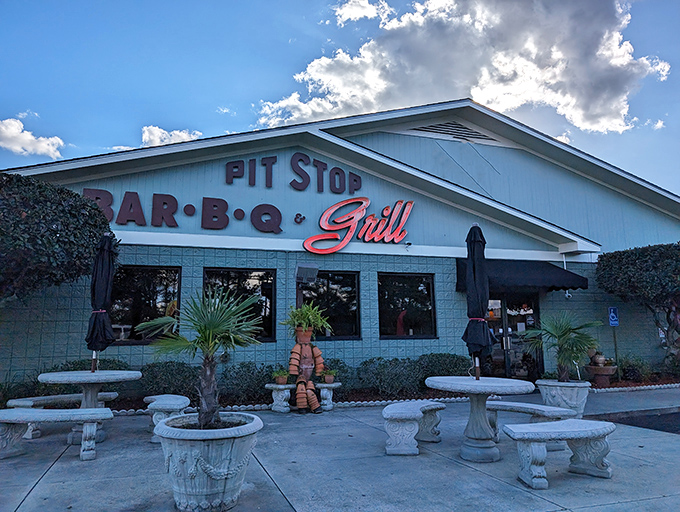 The mint-green sanctuary of smoke beckons from the roadside, with stone tables promising a moment of barbecue bliss before you even step inside.