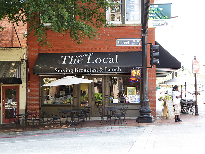 The historic red brick facade of The Marietta Local stands proudly on the corner, promising comfort and community with every meal served.